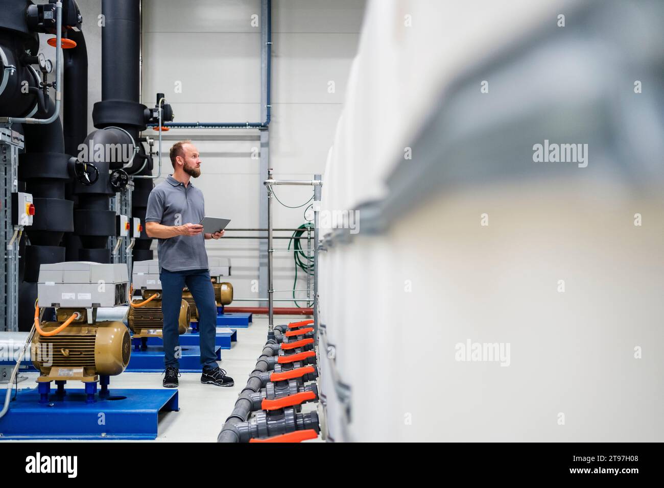 Employee with digital tablet checking system in factory Stock Photo - Alamy