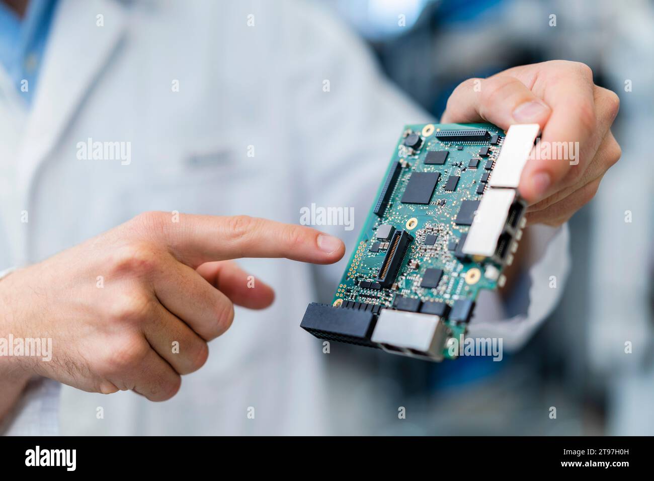 Hand of technician pinting at motherboard Stock Photo - Alamy