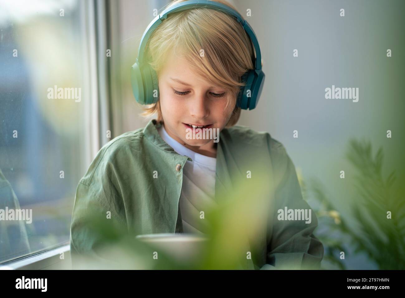 Boy using computer with headphones hi-res stock photography and images ...