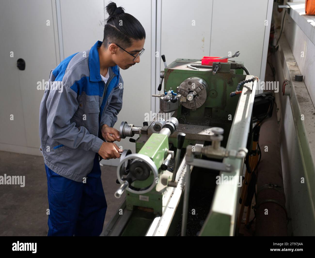 Teenage apprentice operating lathe machine at workshop Stock Photo - Alamy
