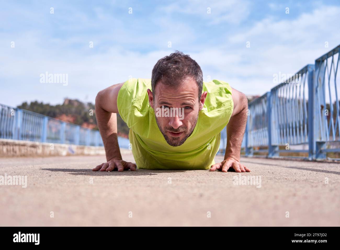 Active man doing push-ups on bridge Stock Photo - Alamy