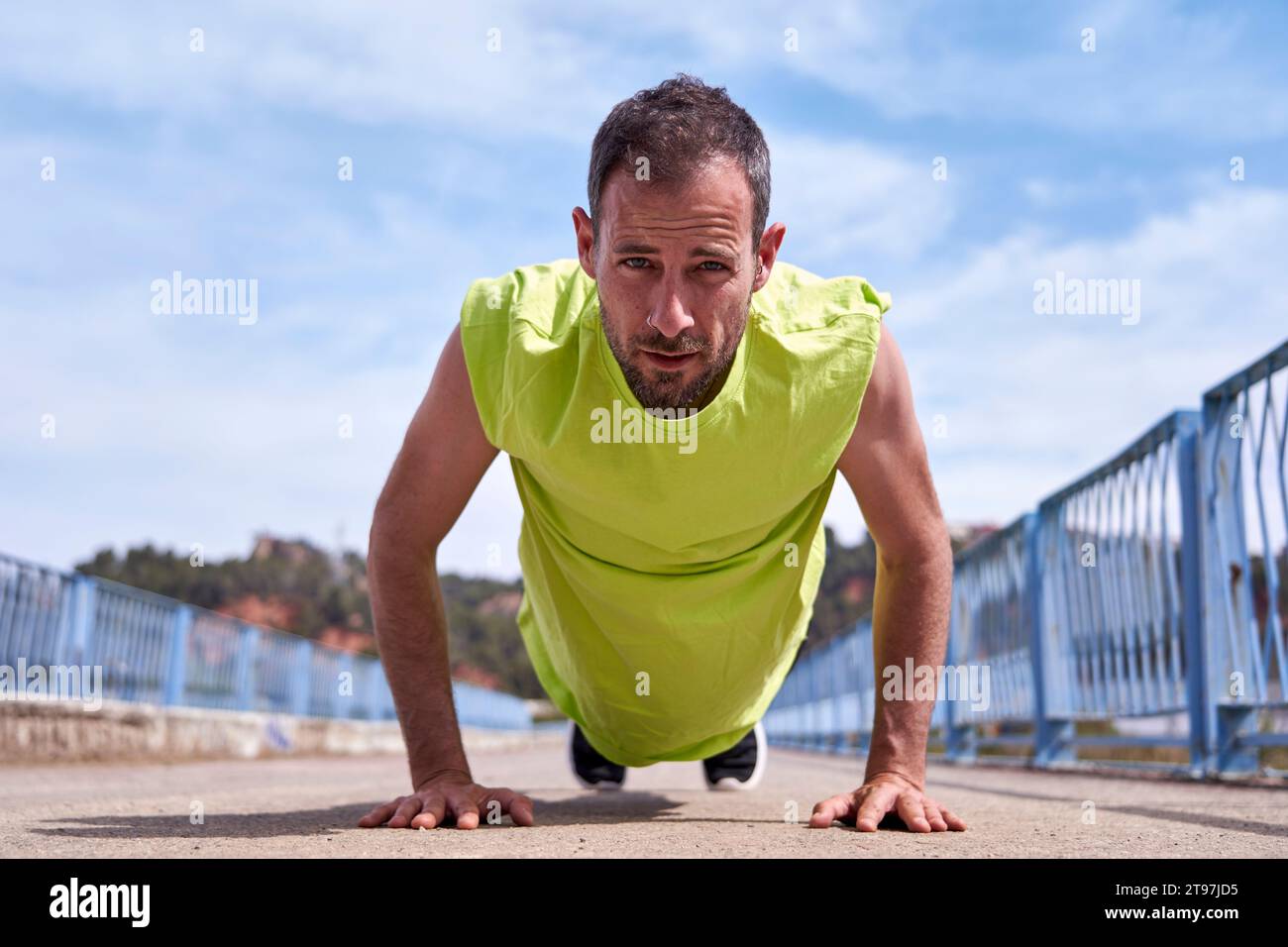 Active man exercising and doing push-ups on bridge Stock Photo - Alamy
