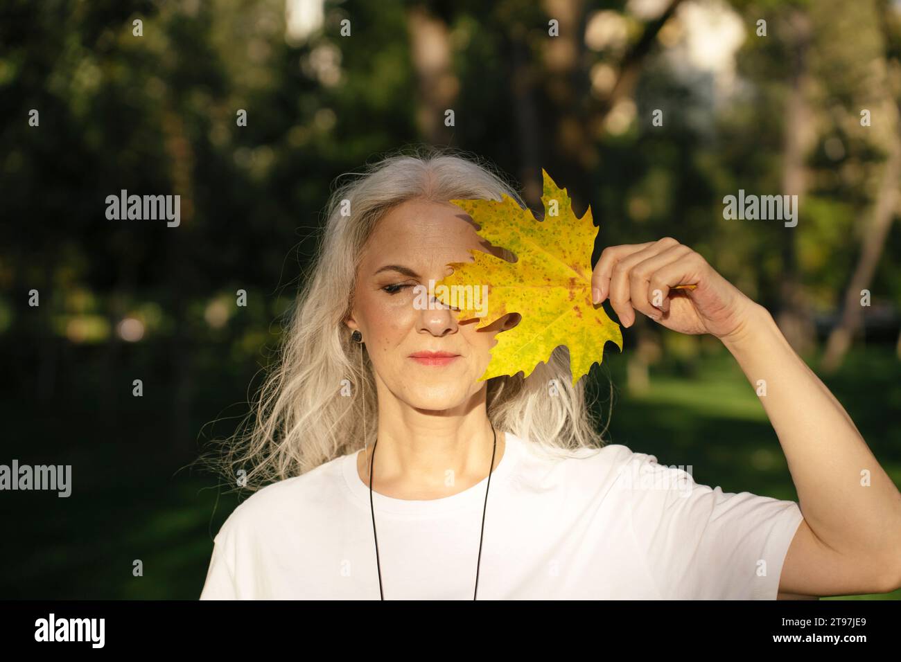Mature woman holding maple leaf hi-res stock photography and images - Alamy