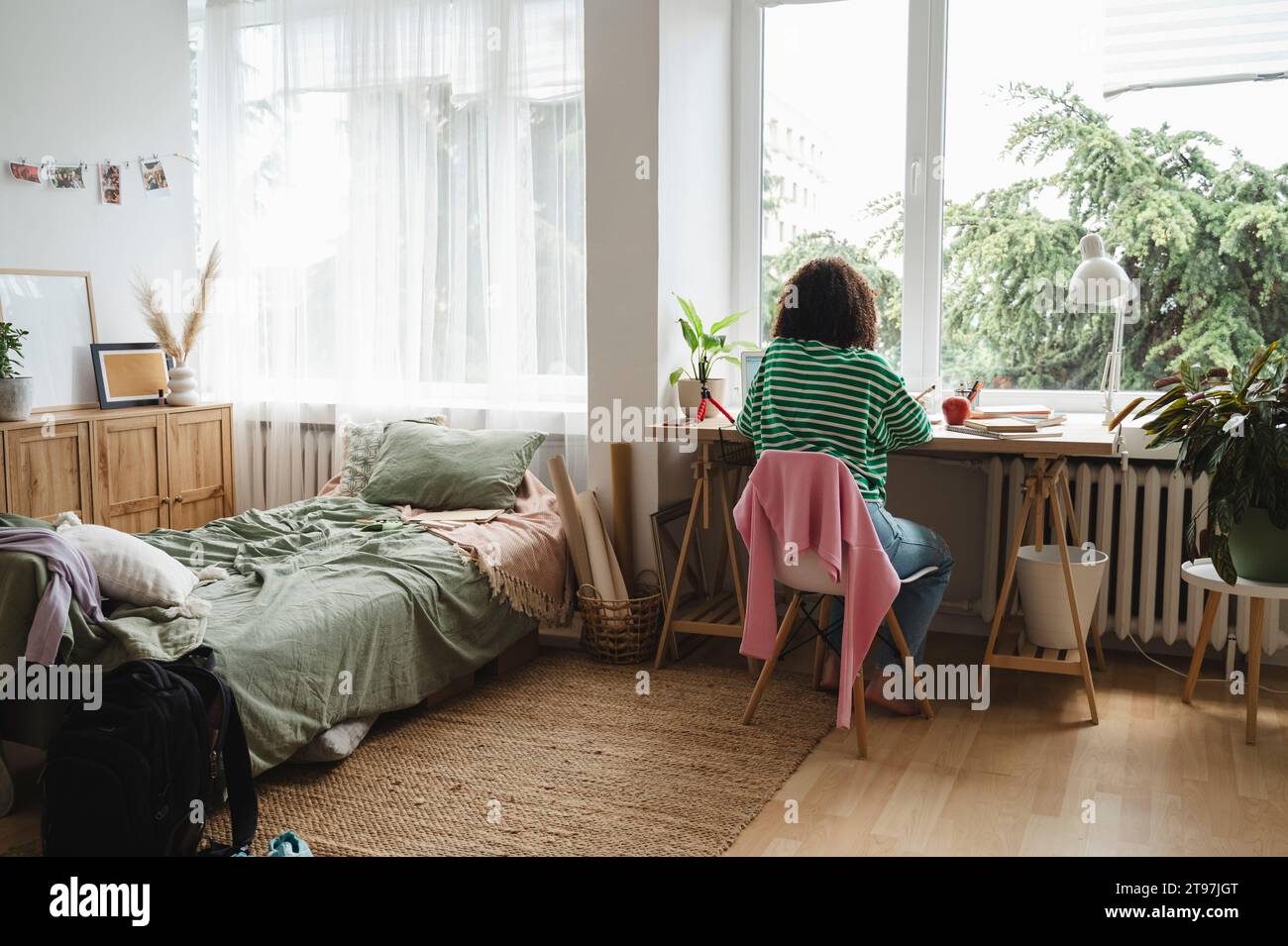 Girl doing homework at desk in bedroom Stock Photo - Alamy