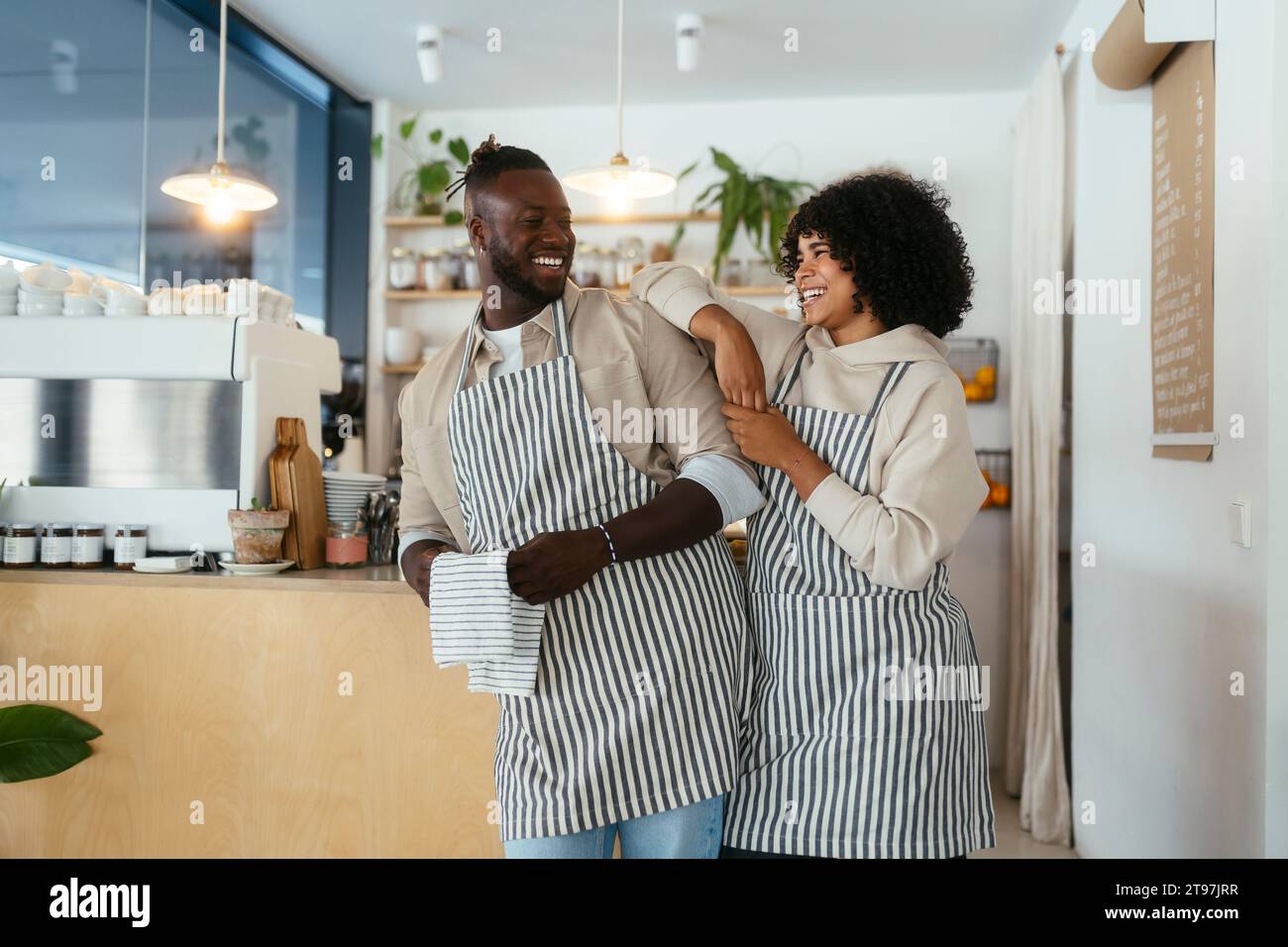 Happy baristas standing together near counter at coffee shop Stock ...