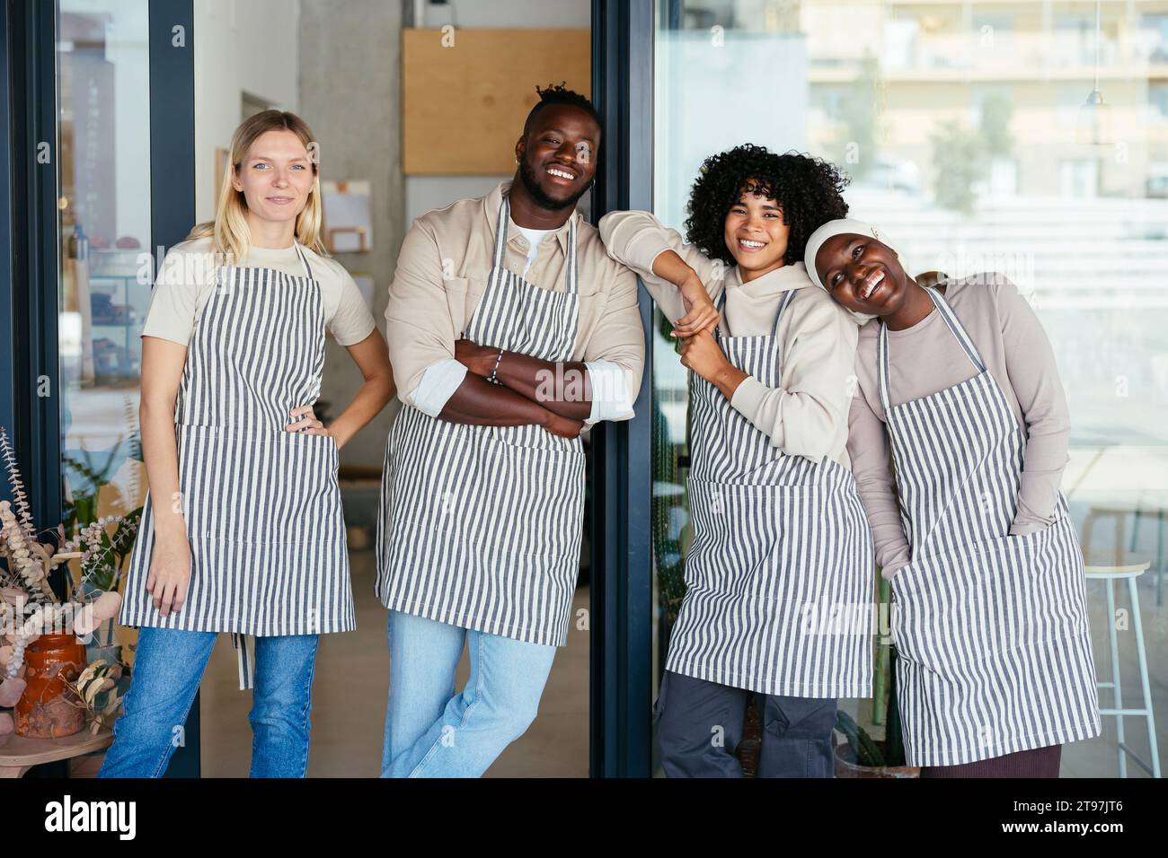 Smiling baristas standing together in cafe doorway Stock Photo - Alamy