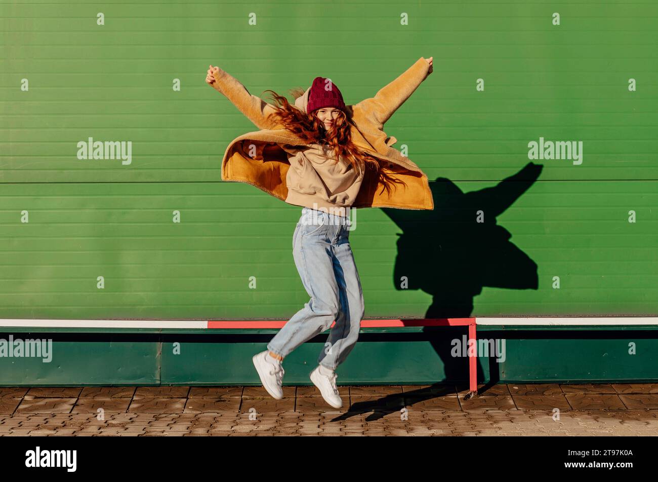 Woman raising arms in green hi-res stock photography and images - Alamy