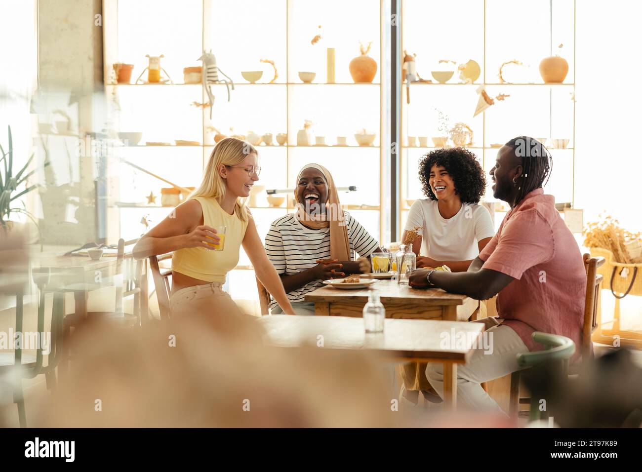 Friends laughing and having fun at coffee shop Stock Photo - Alamy