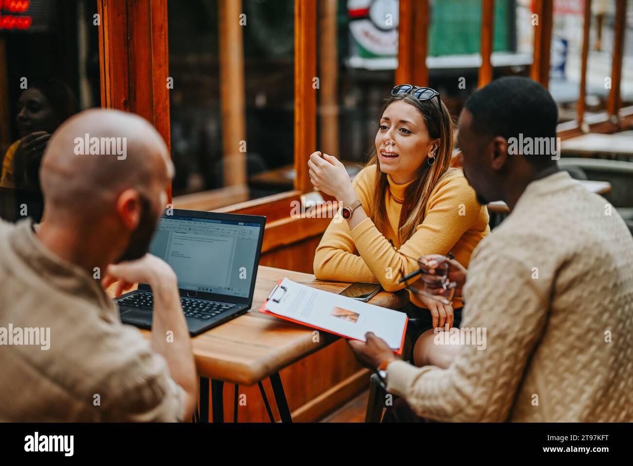 Young, multiracial corporate team collaborates on business ideas at a ...
