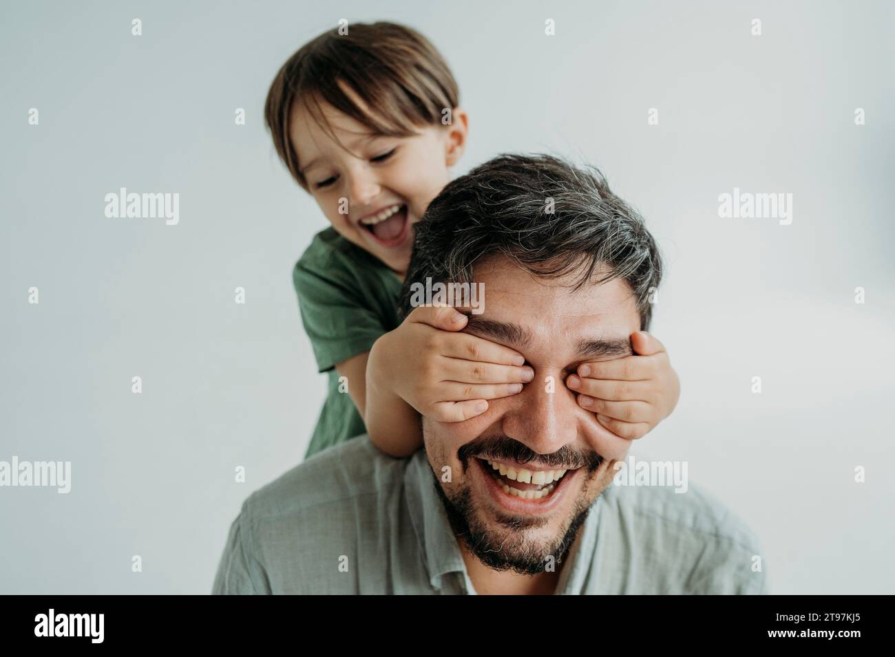 Son covering father eyes hi-res stock photography and images - Alamy