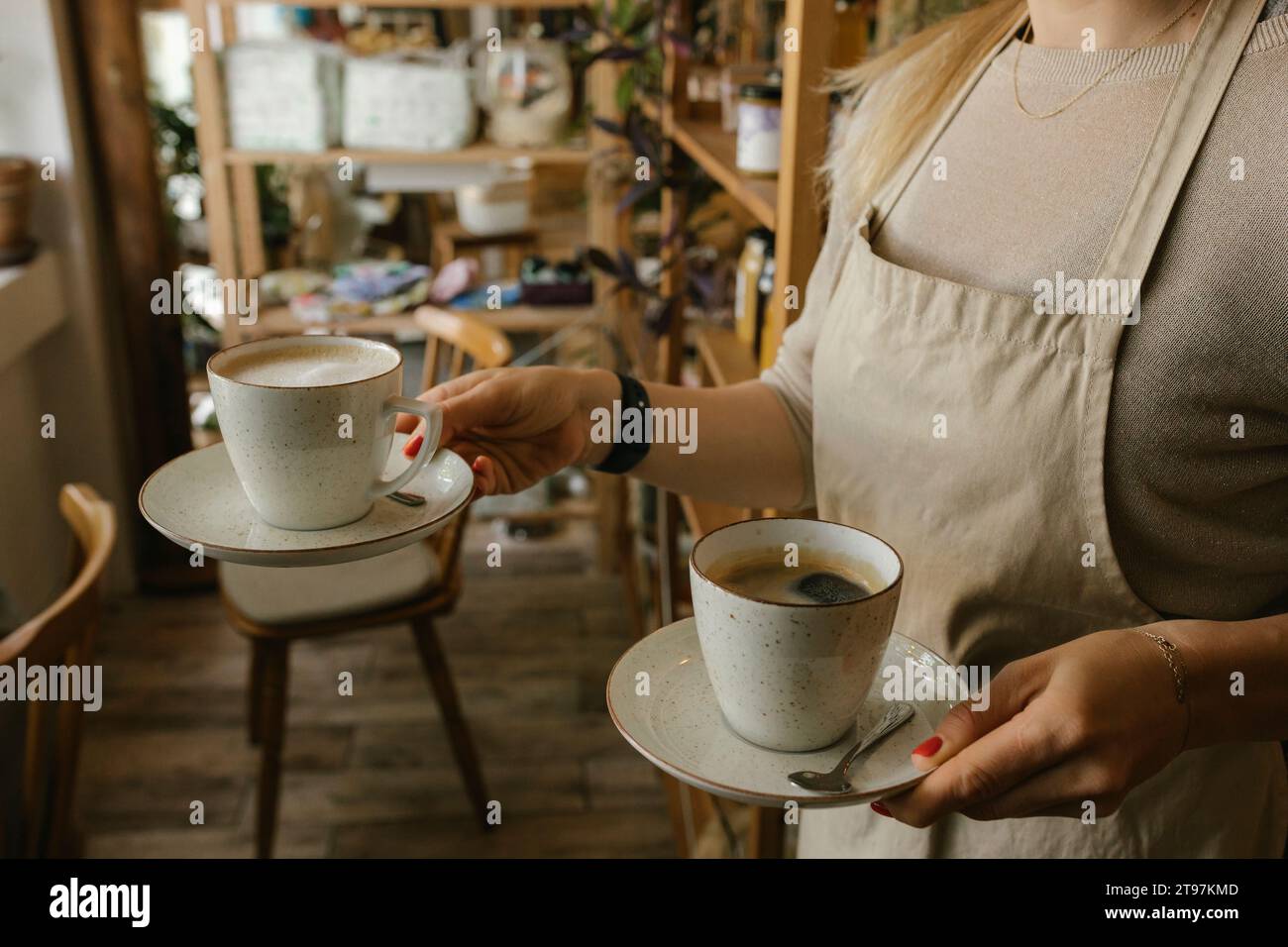 Female employee wearing apron hi-res stock photography and images - Alamy