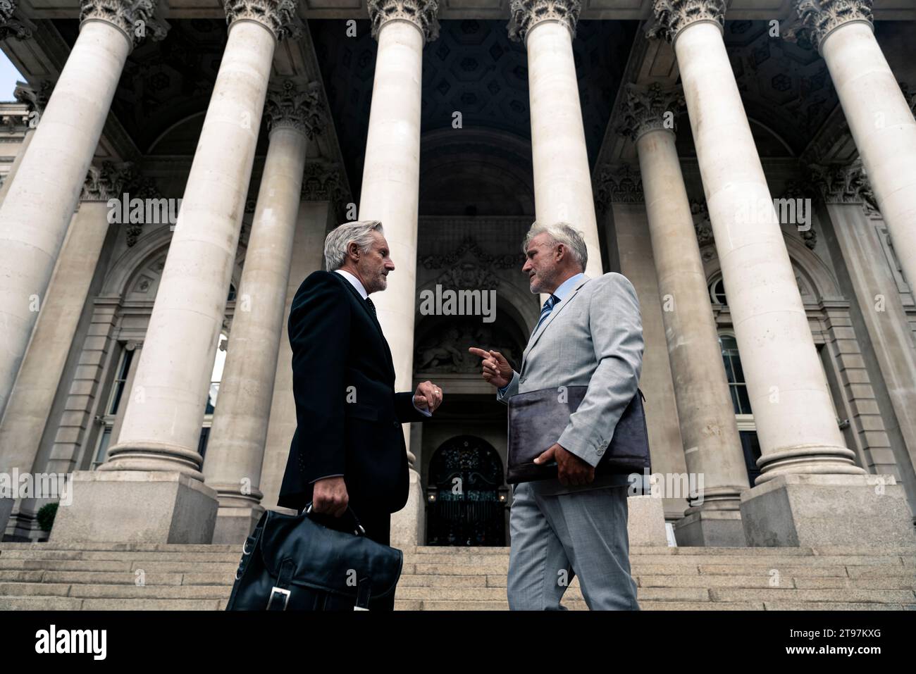 Senior businessman gesturing and talking to each other in front of ...