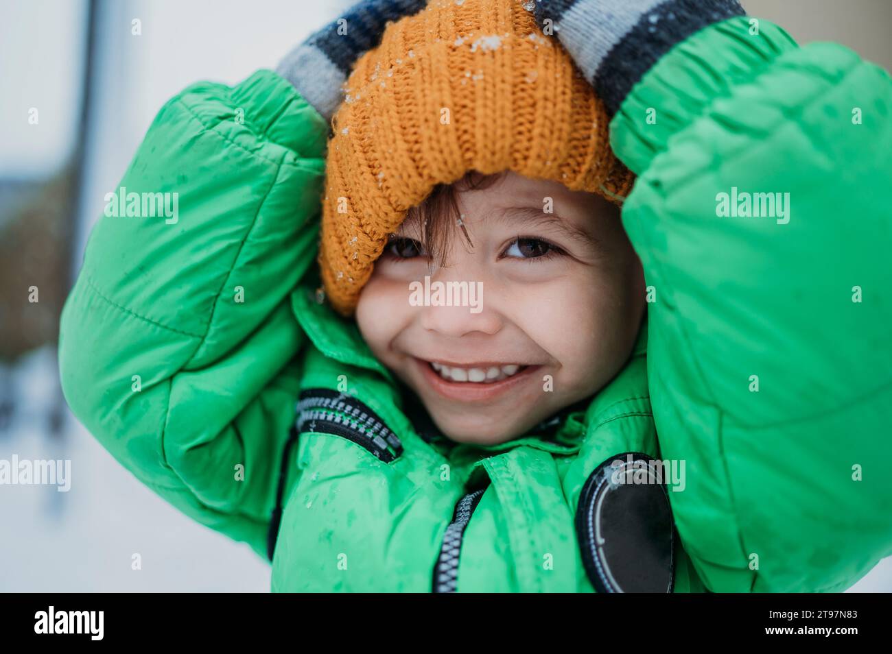 Happy boy wearing yellow knit hat in winter Stock Photo - Alamy