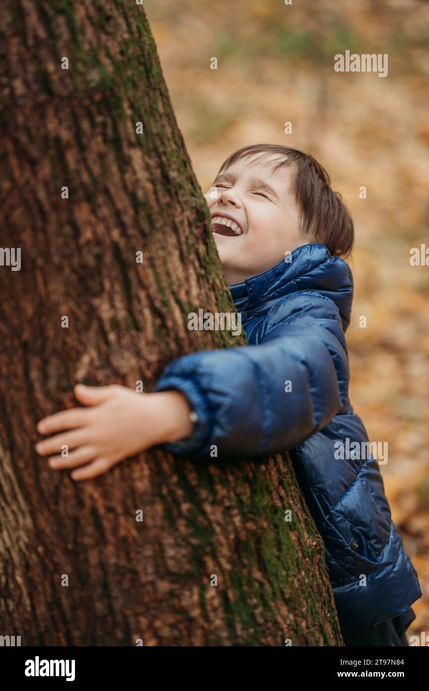 Boy hugging tree hi-res stock photography and images - Alamy