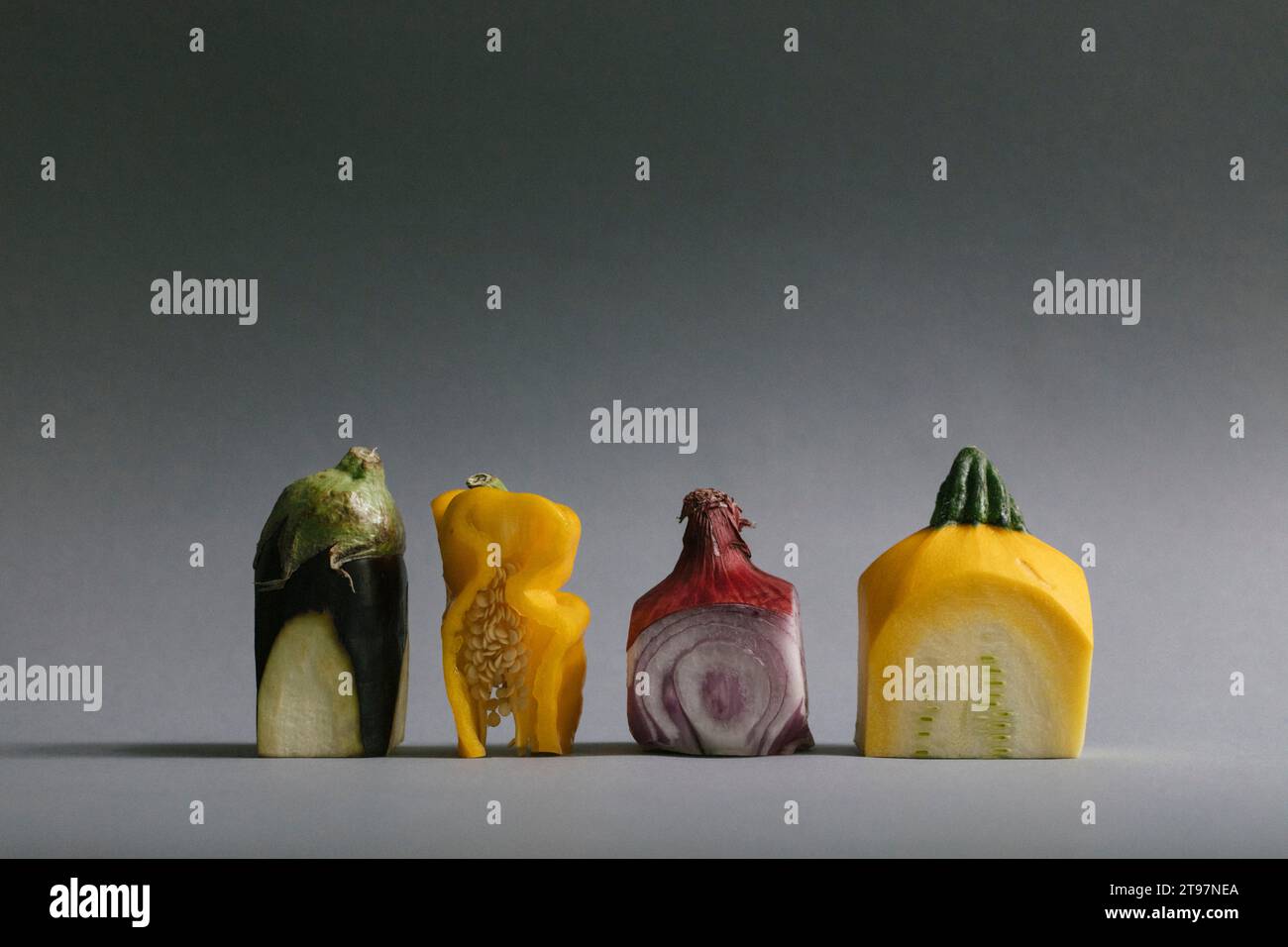 Four halved vegetables against gray background Stock Photo - Alamy