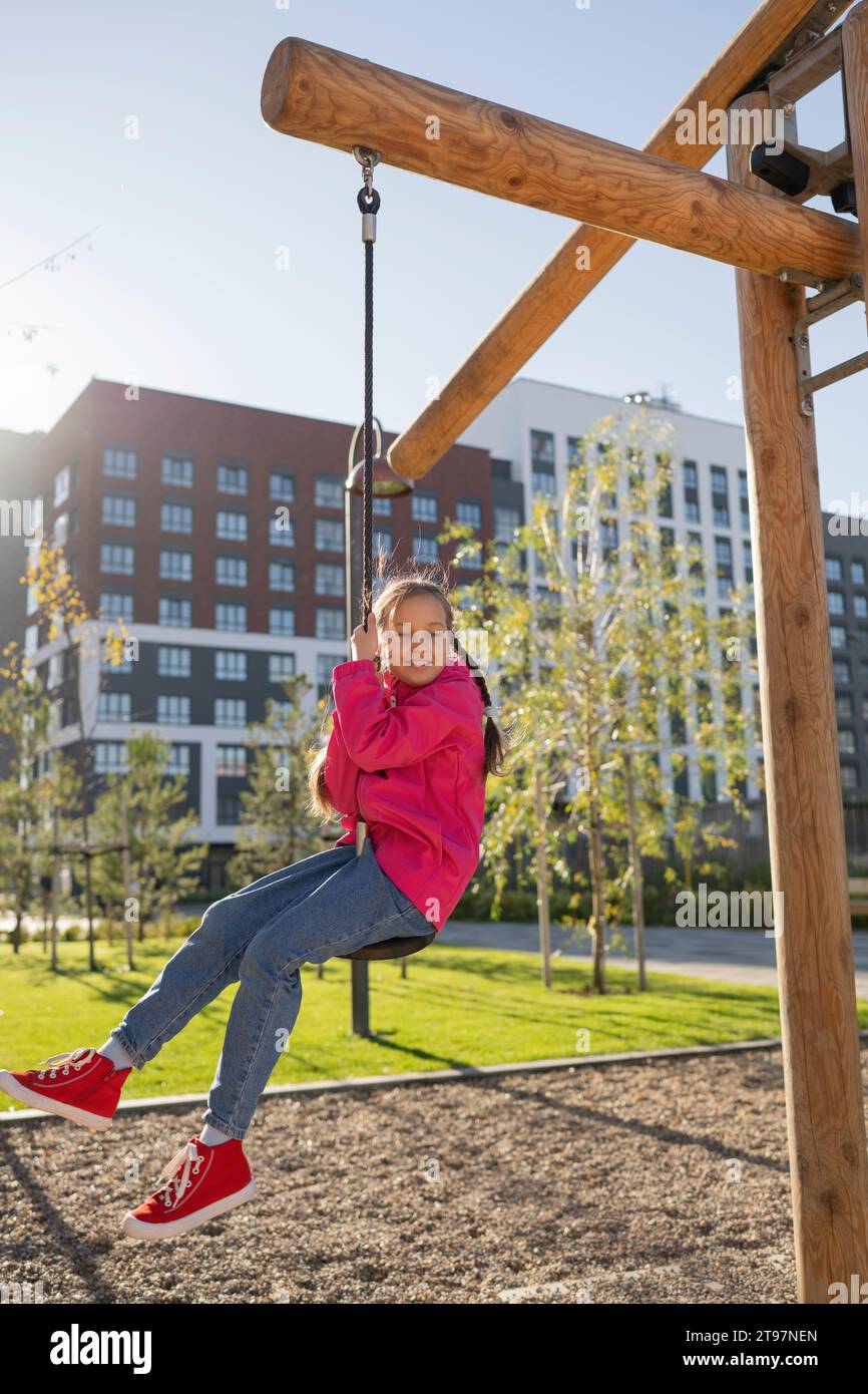 Girl on swing playground hi-res stock photography and images - Alamy
