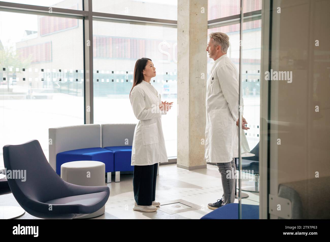 Doctors having discussion in laboratory lobby Stock Photo - Alamy