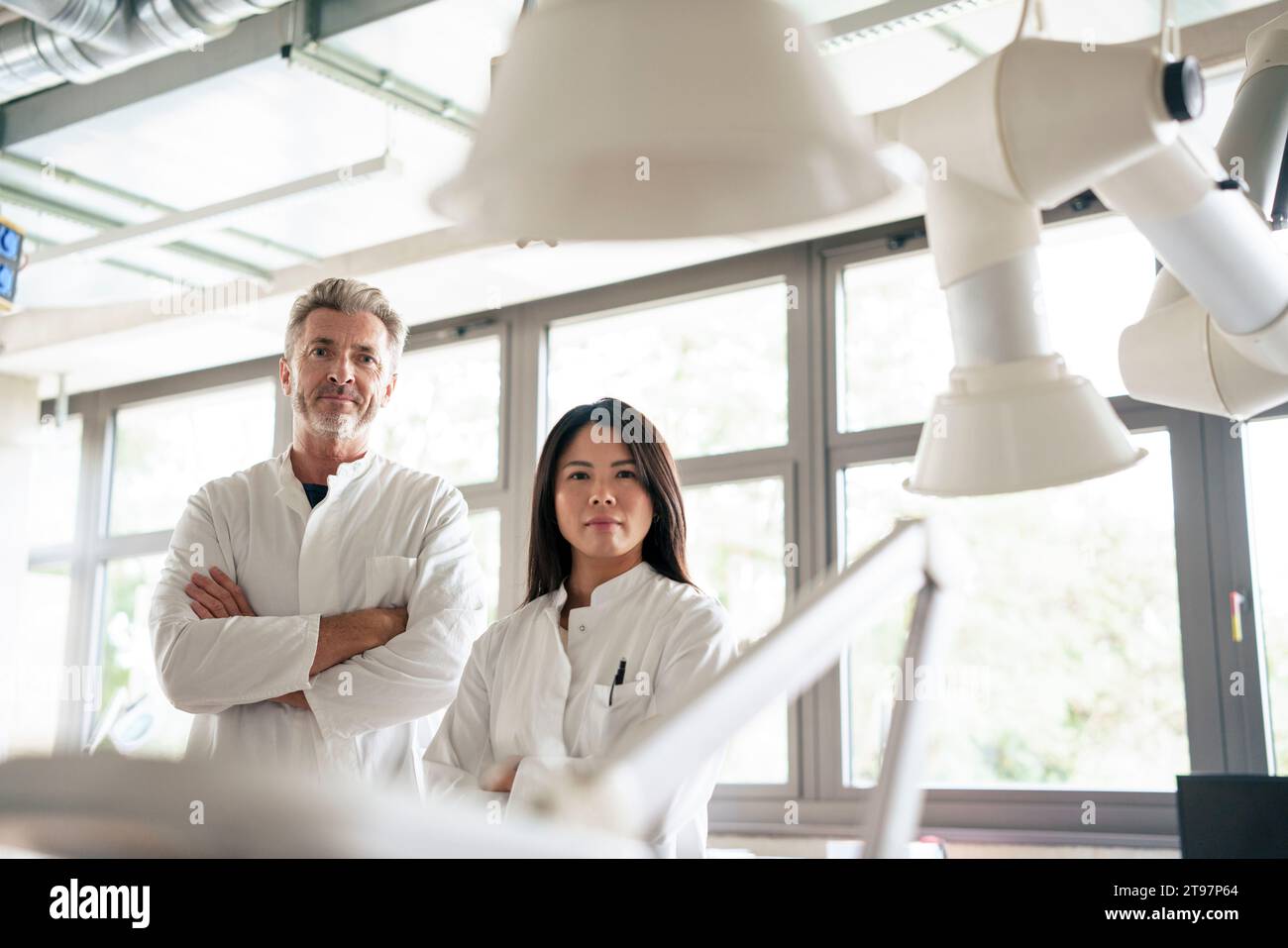 Scientists standing together near robotic arms Stock Photo - Alamy