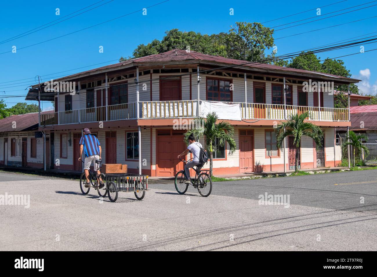People riding bicycles in the coastal town of Puerto Cortes in ...
