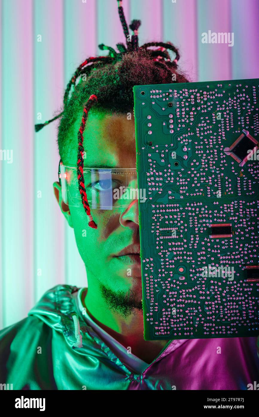 Man wearing smart glasses covering face with computer chip Stock Photo ...