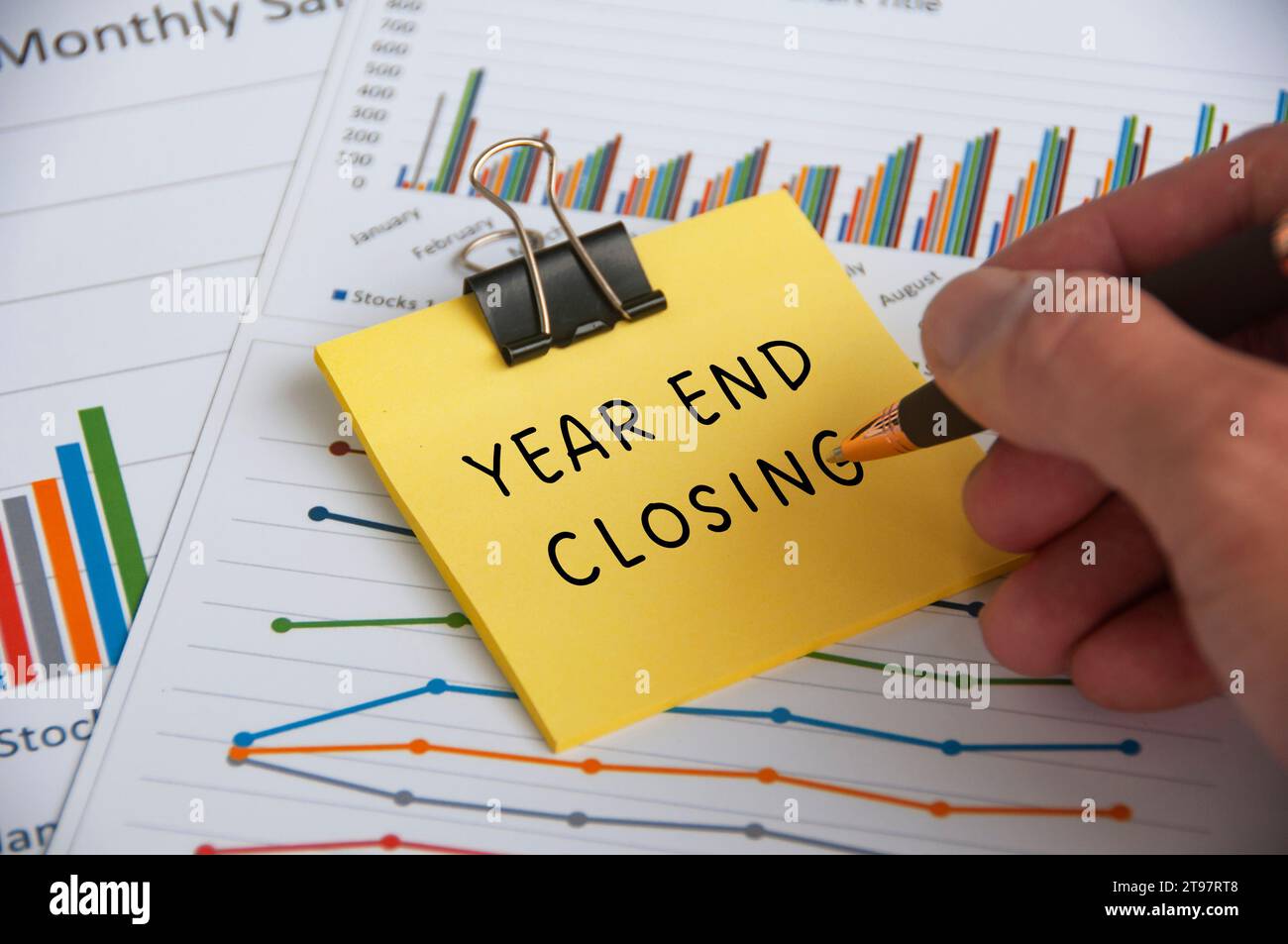 Hand writing Year End Closing text on sticky note with statistic and ...