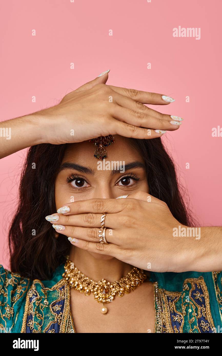 vertical shot of indian woman in national costume covering face with ...
