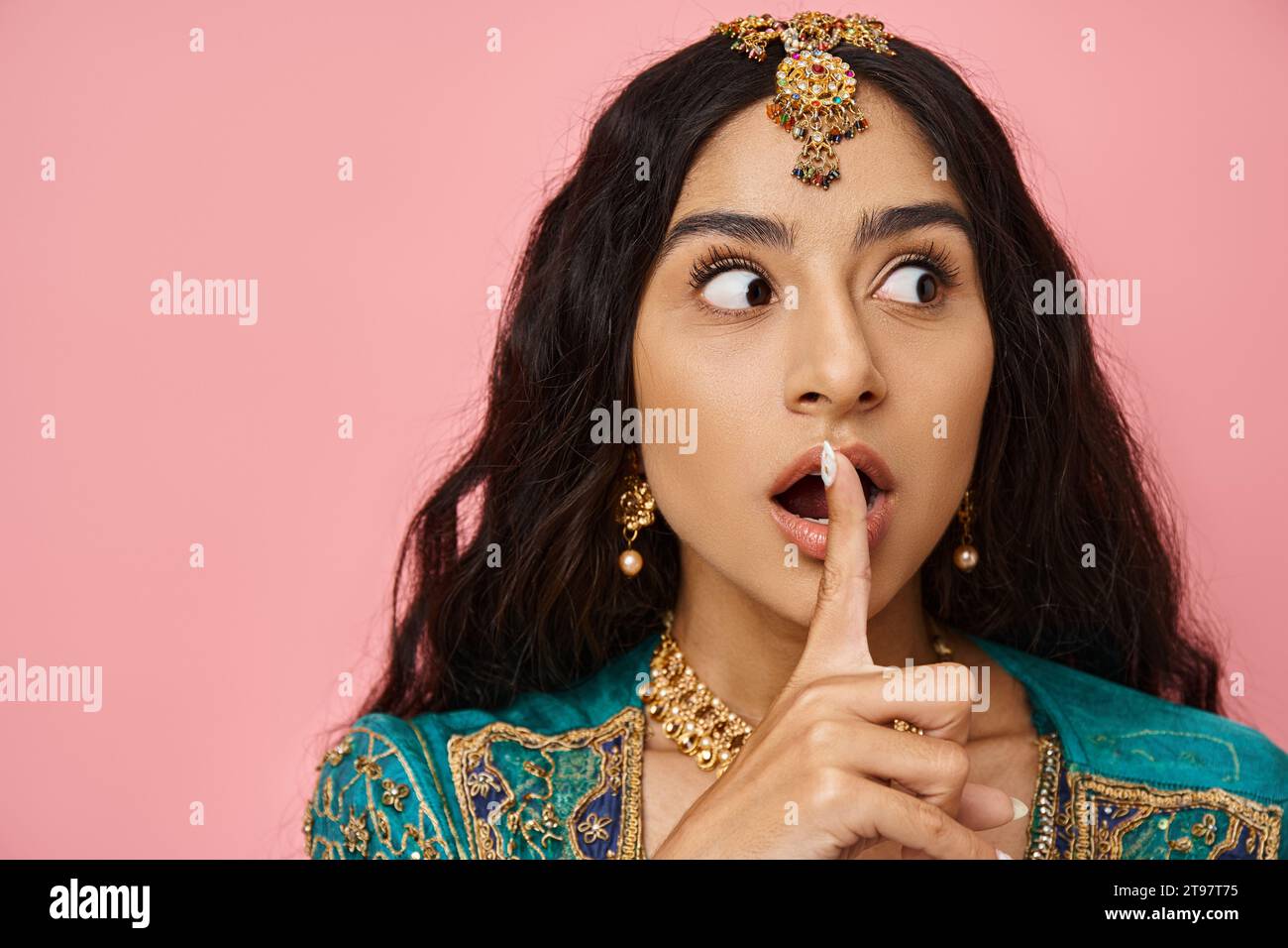 shocked young indian woman in traditional costume posing with finger ...