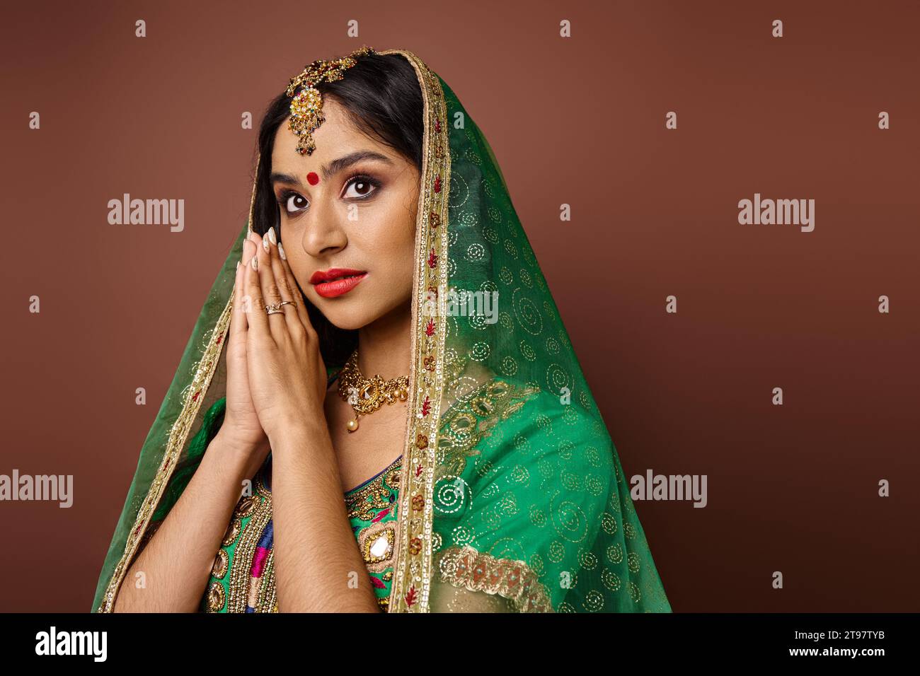 pretty indian woman in traditional costume with bindi dot showing ...