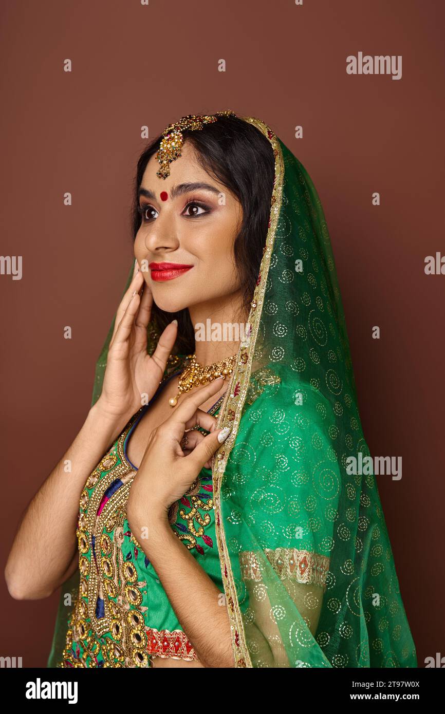 vertical shot of jolly indian woman in traditional clothes with ...