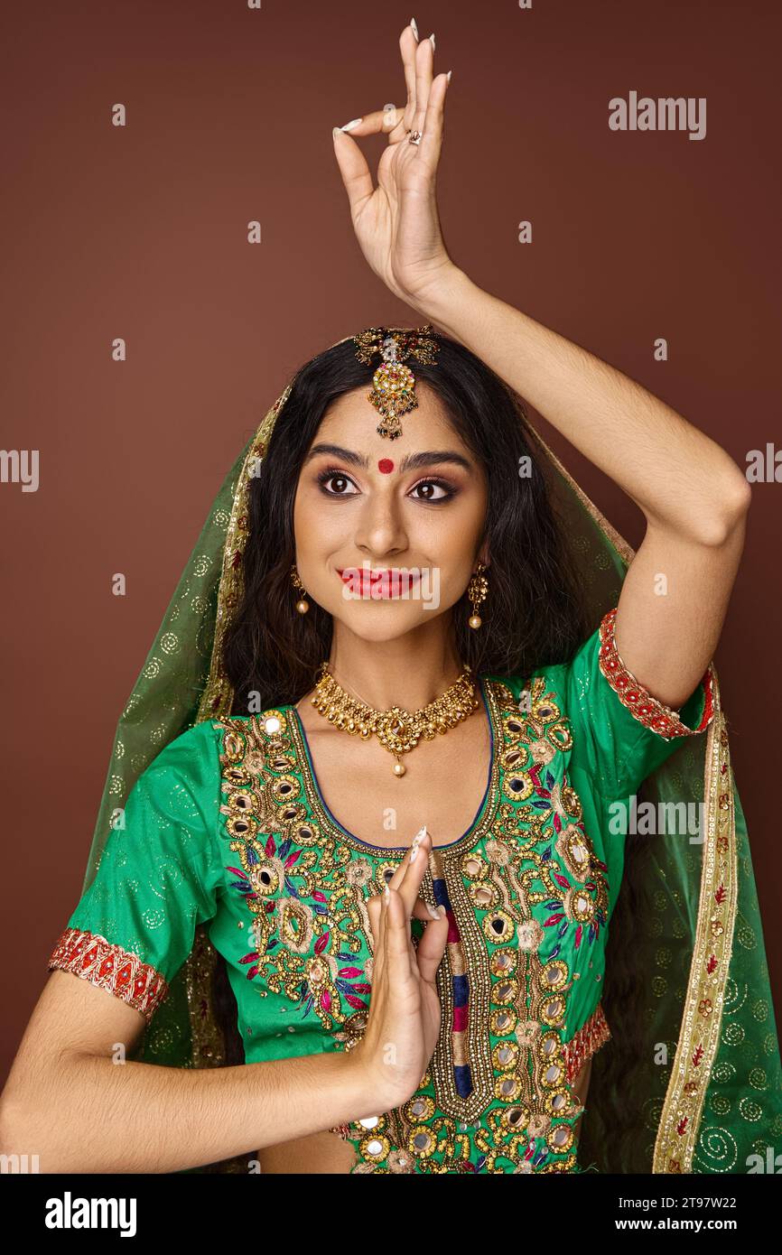 vertical shot of pretty joyful indian woman with veil and bindi ...