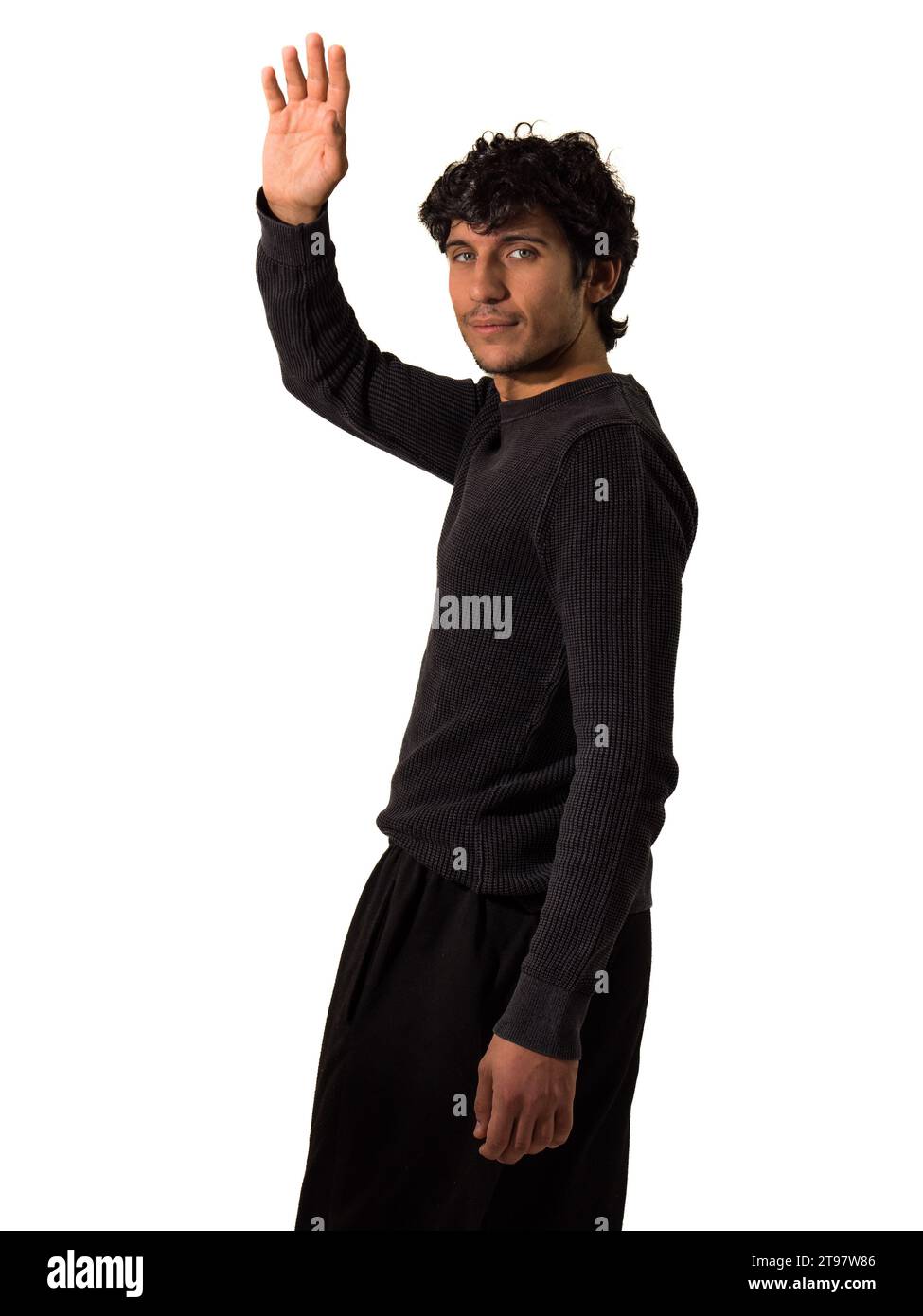 A man in a black shirt and black pants greeting with one hand, saluting ...