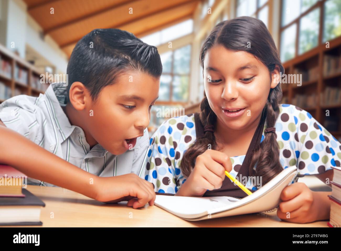 Hispanic School Kids Doing Homework Together in the Library Stock Photo ...