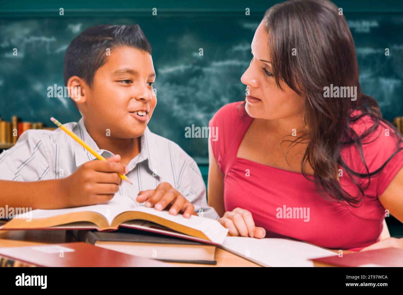 Female School Teacher Doing Homework with a Young Hispanic Boy in the ...