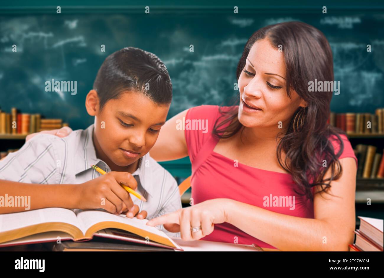 Female School Teacher Tutoring a Young Hispanic Boy in the Classroom Stock Photo - Alamy