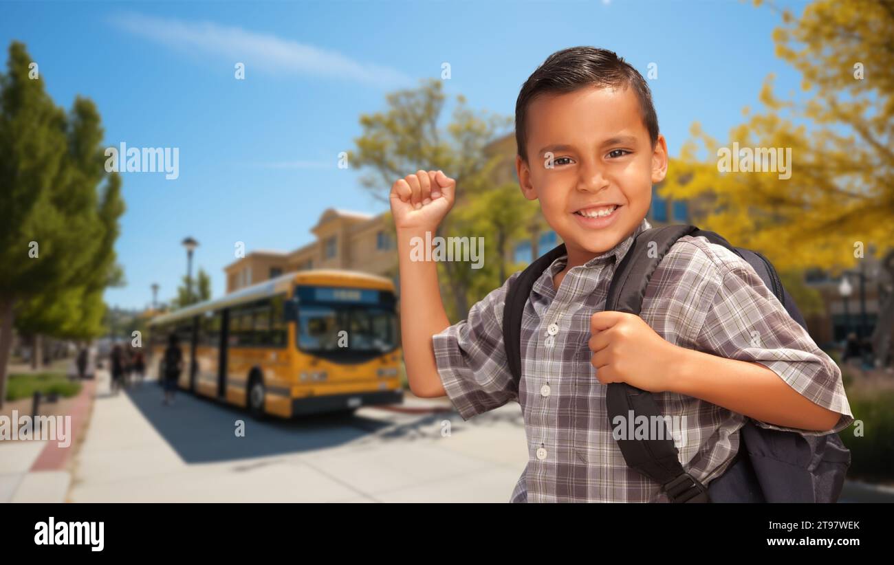 Excited Young Hispanic Boy Wearing a Backpack Near a School Bus on ...