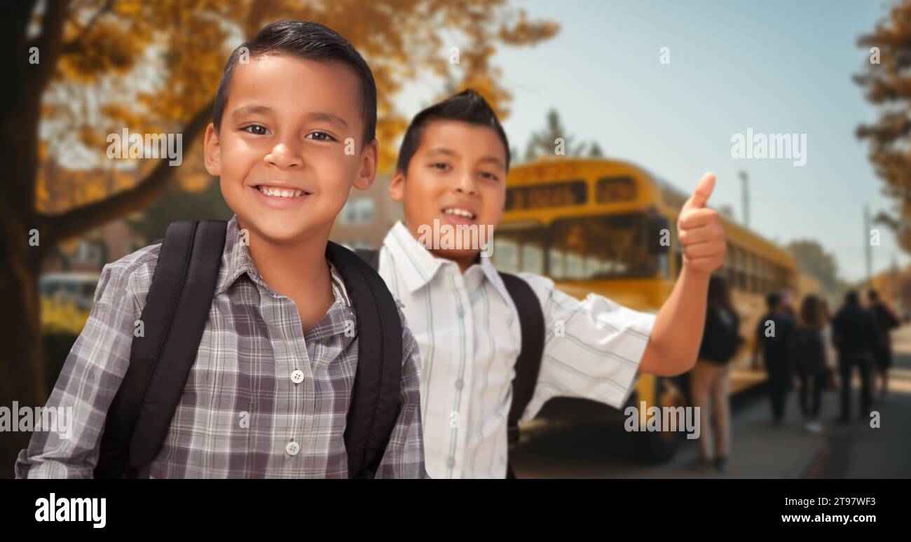 Two Happy Young Hispanic Boys Wearing Backpacks Give a Thumbs Up on ...
