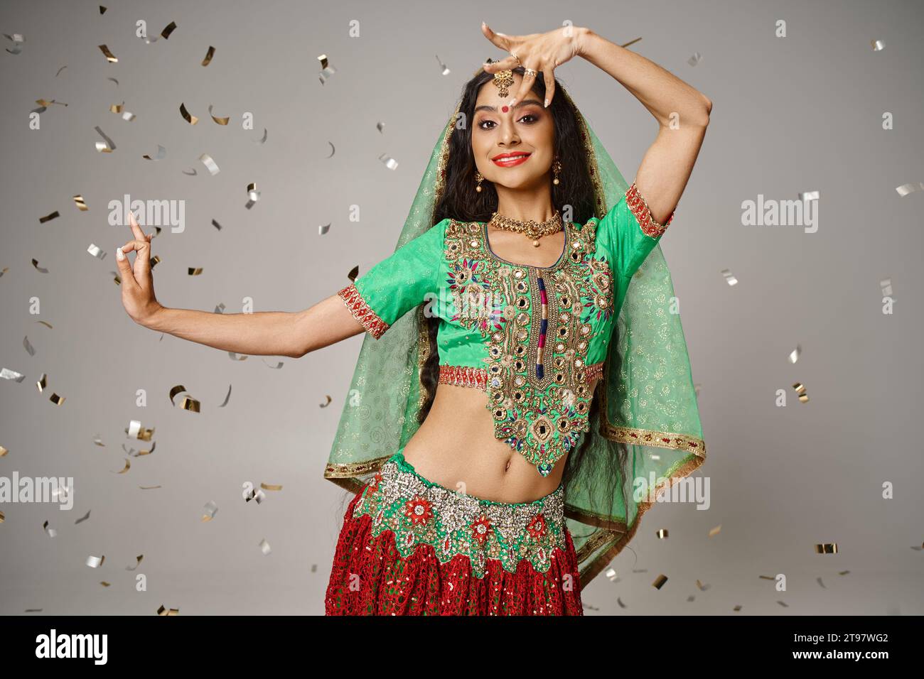 attractive indian female model in traditional clothes posing in motion ...