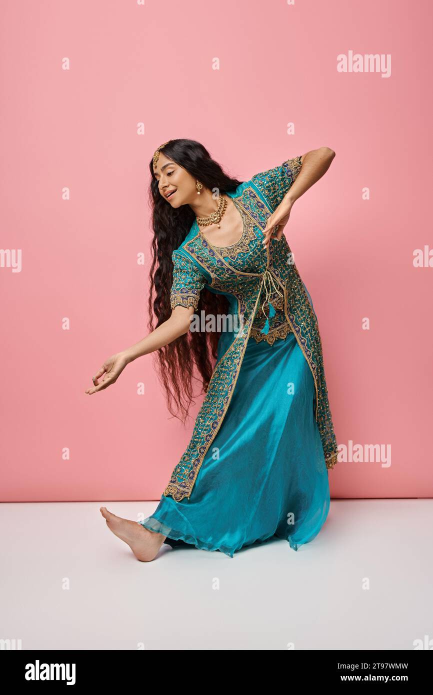 good looking indian woman in traditional blue sari gesturing while ...