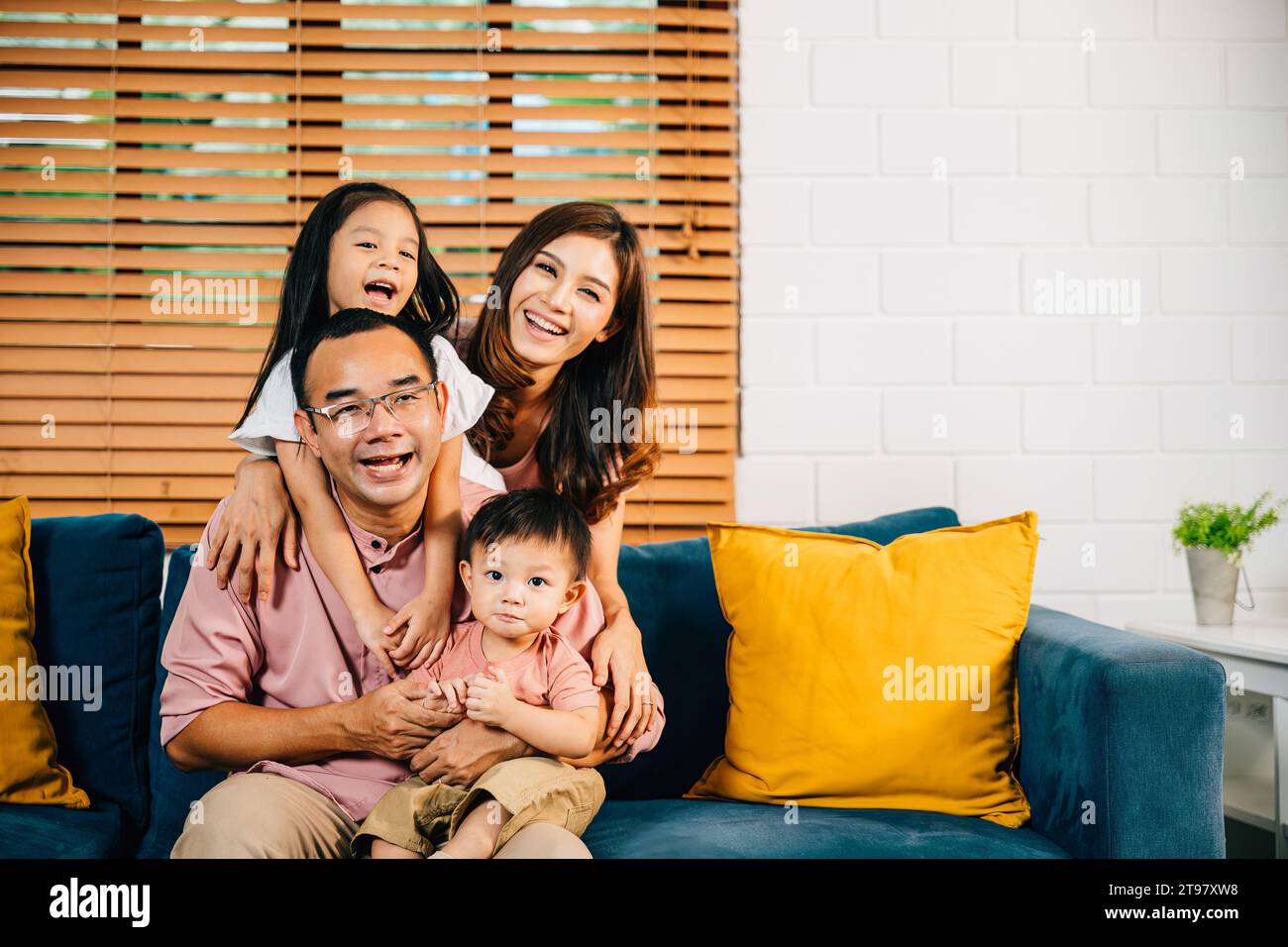 A joyful family in their comfortable modern house enjoys quality time ...