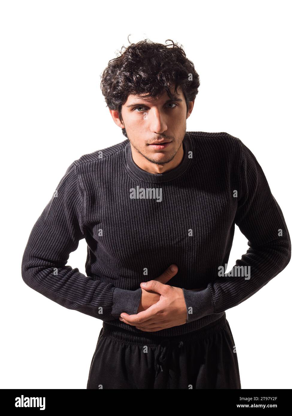 A young man is suffering from belly-ache, stomach ache, in a black ...