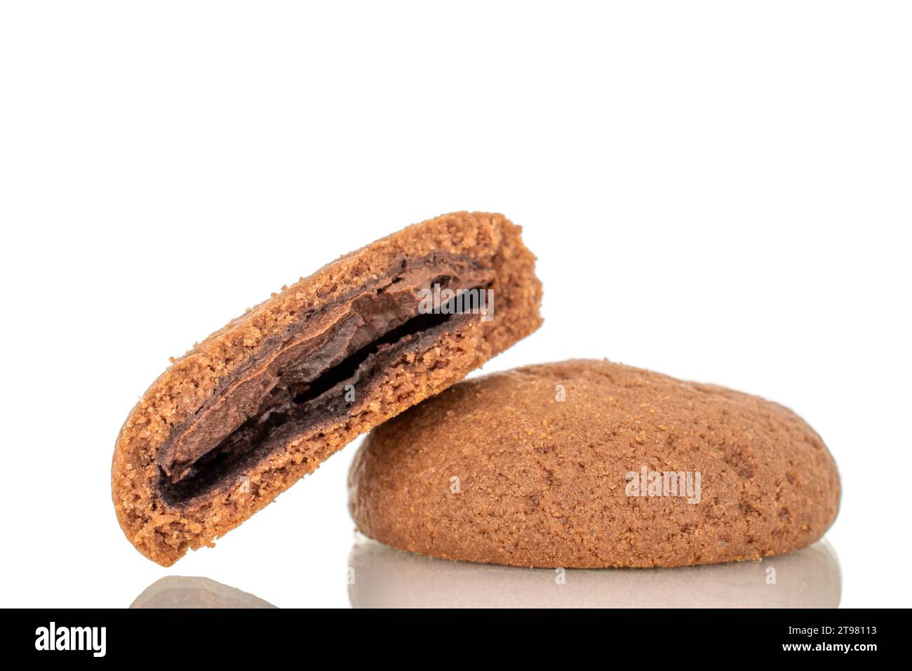 One whole chocolate chip cookie and one half, macro, isolated on white ...