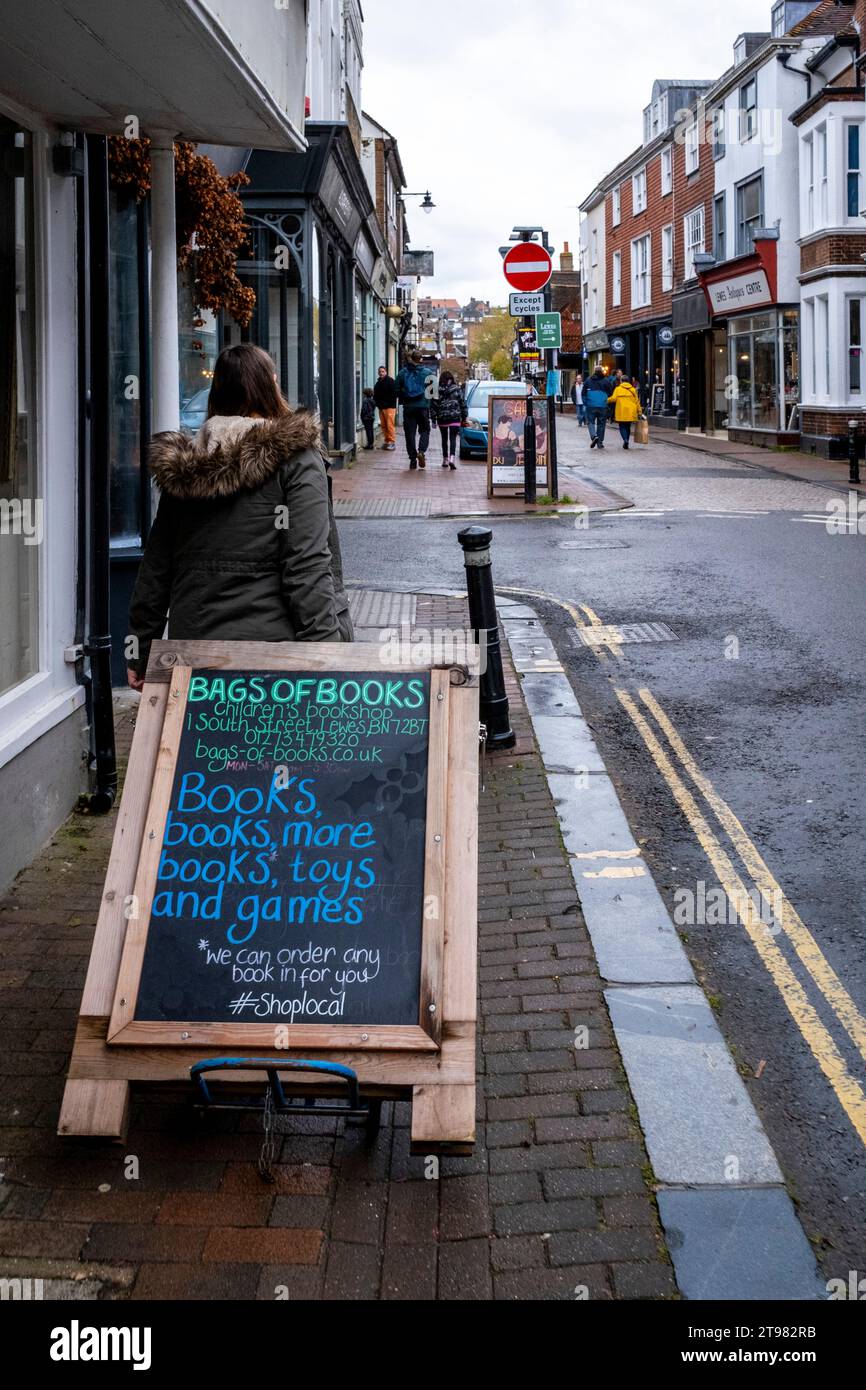 A Shop Owner Takes An Advertising Board To Place In The High Street ...