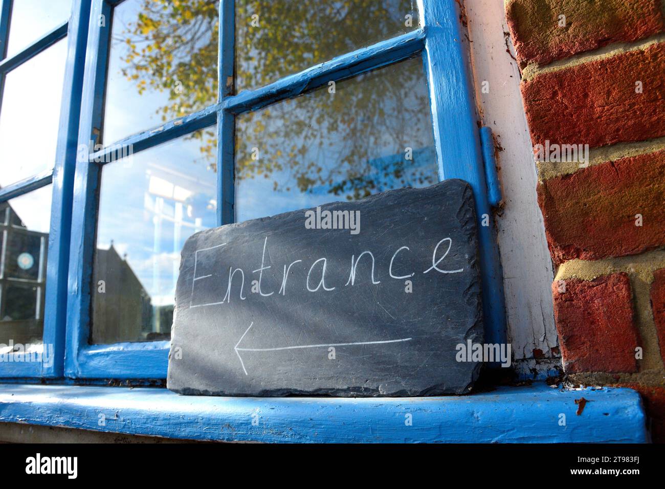 Entrance sign hand written on slate stone Stock Photo - Alamy