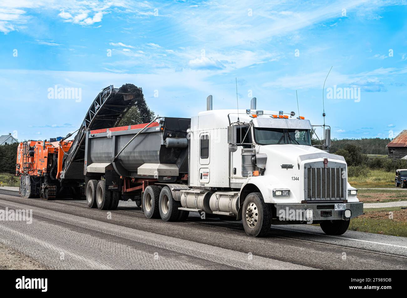 Macamic, Quebec, Canada, 2023-08-21 : Orange planing machine removing a ...