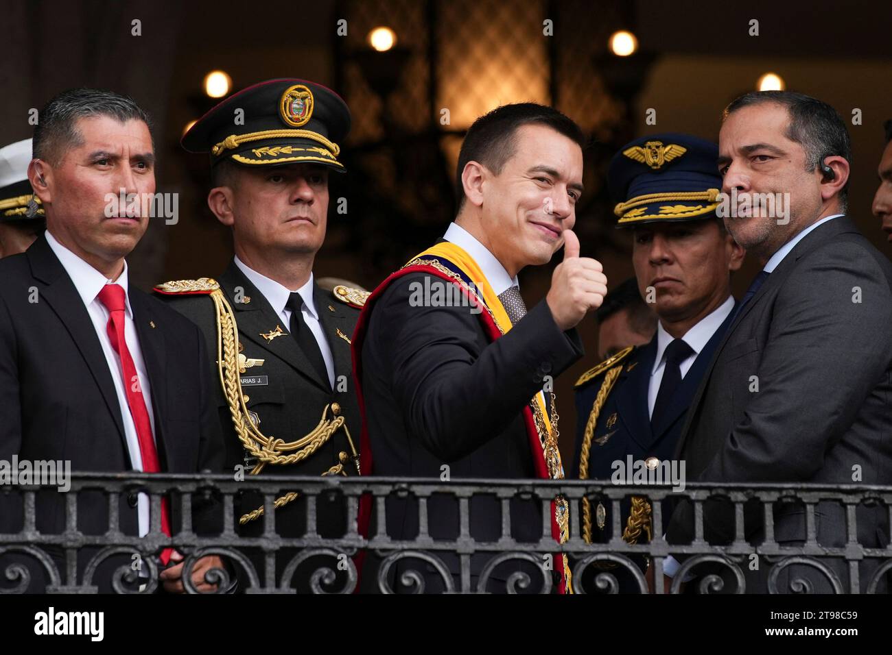 Newly sworn-in President Daniel Noboa flashes a thumbs-up from a balcony of the Carondelet ...