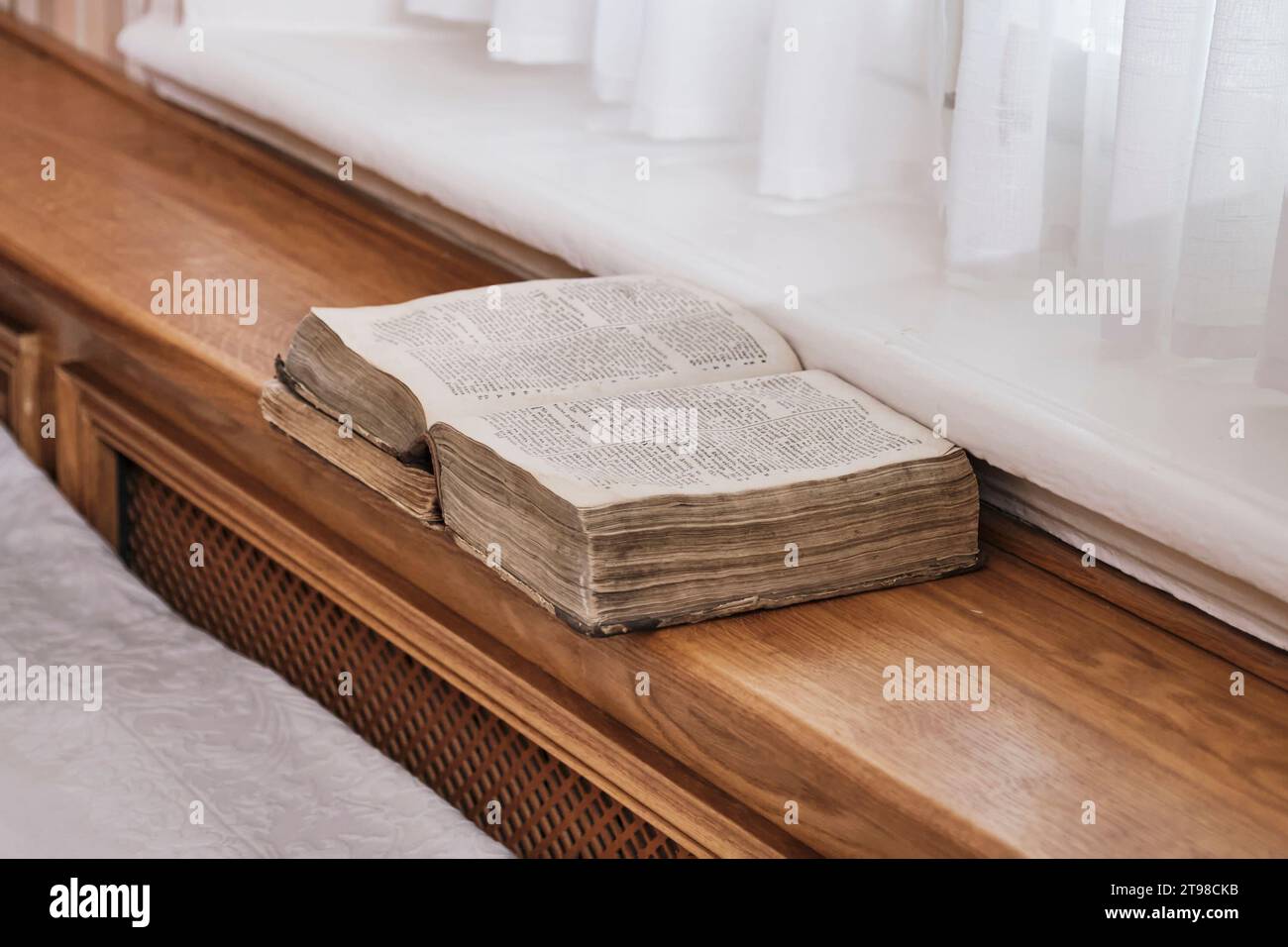Antique open book of Bible with battered pages in Church Slavonic lying ...