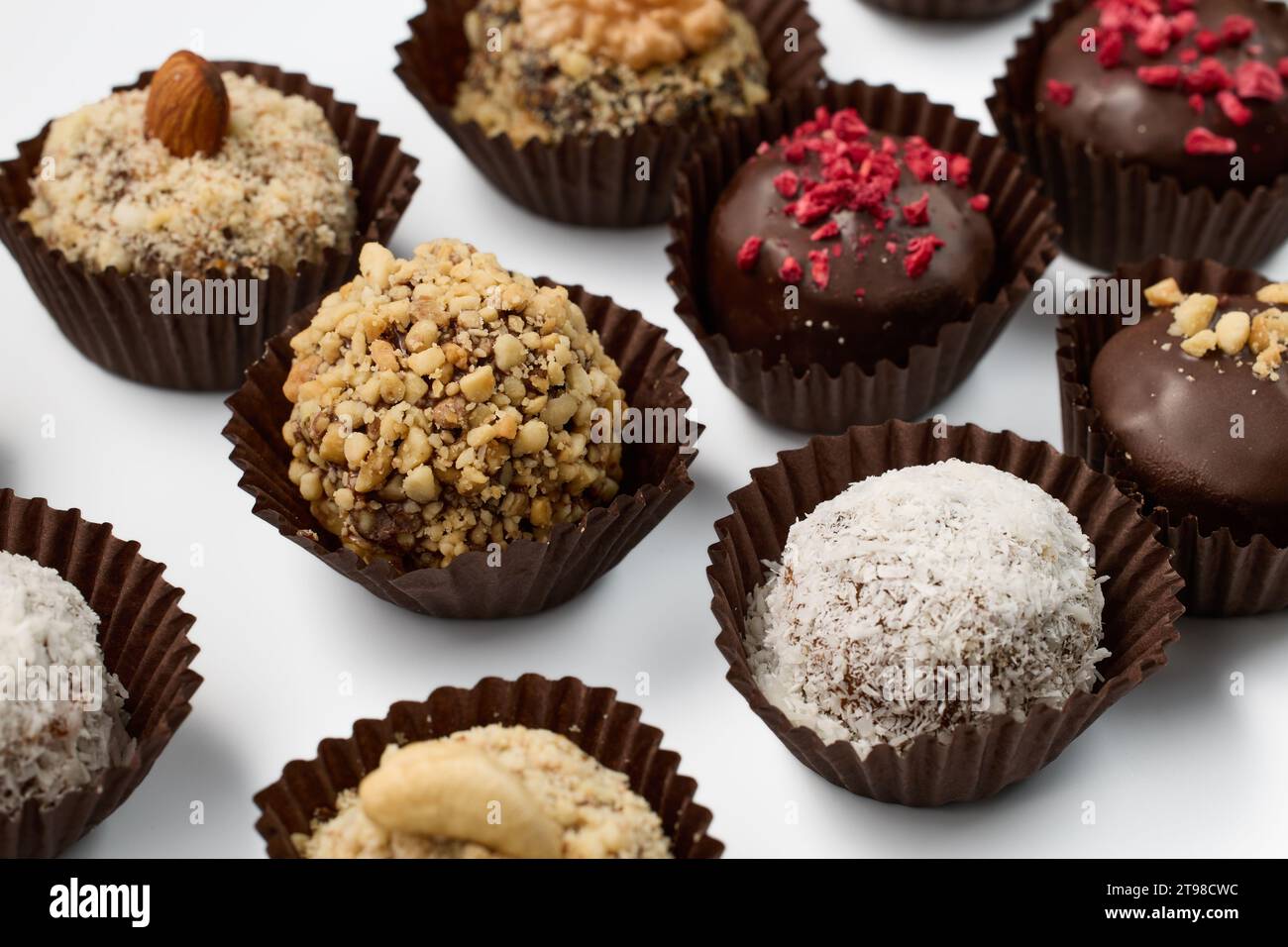 Set of round chocolate candies with nuts on a white background, close ...