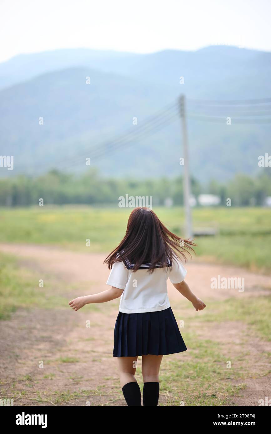 Japanese high school student running in countryside Stock Photo - Alamy
