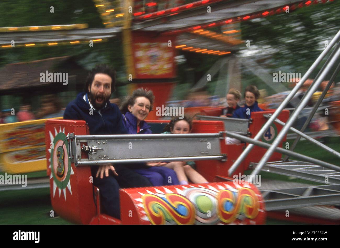 1980s, a family, mum, dad and young daughter sitting together enjoyihg ...
