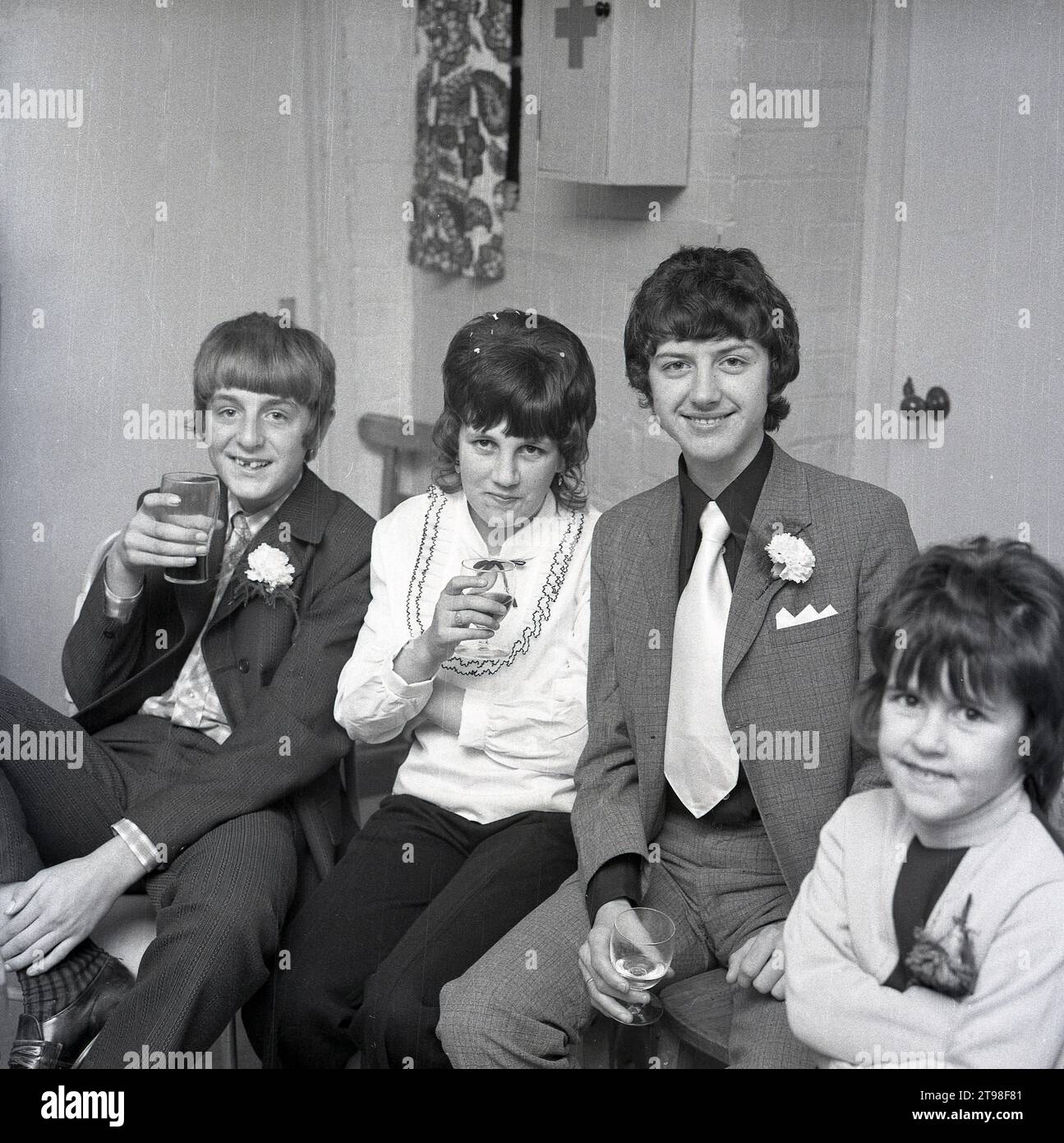 1960s, historical, youngsters smiling for the camera as they have their ...